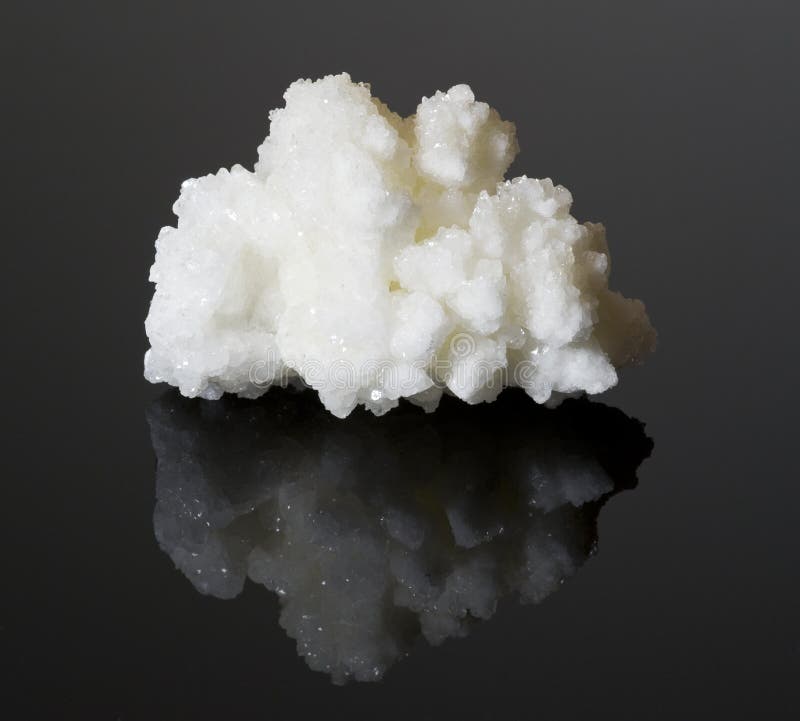 White Quartz Crystals on Reflective Black Surface Stock Image - Image ...