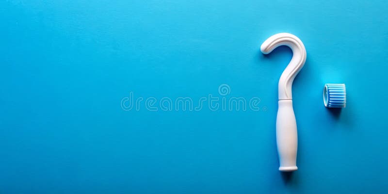 White Question Mark Shaped Handle with Blue Brush Head on Blue ...