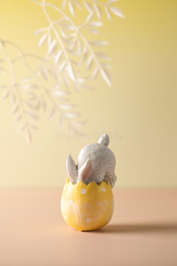 A White Rabbit Hid in an Easter Egg on a Yellow Background. Festive ...