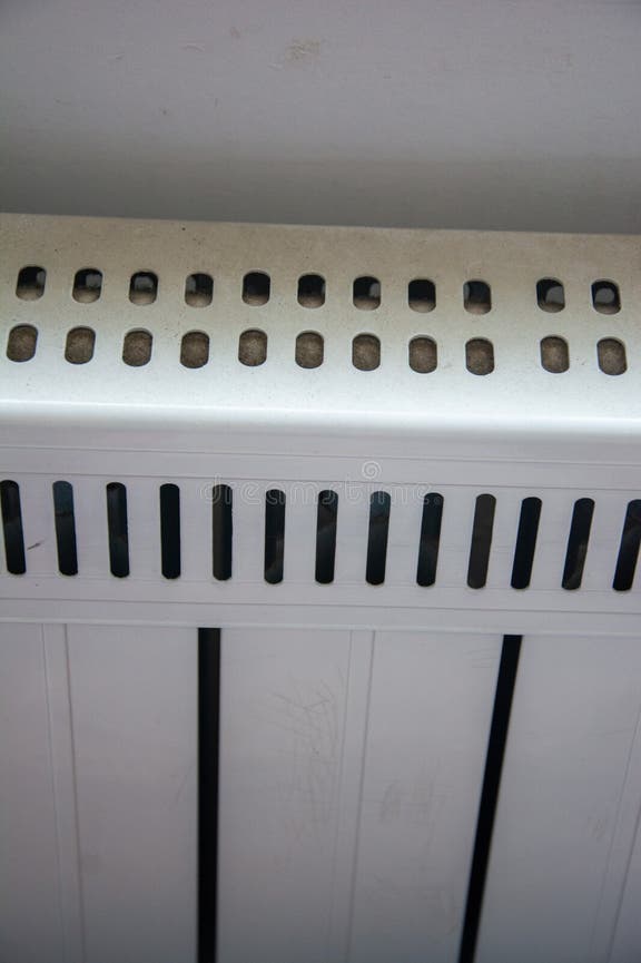 Close Up of White Radiator with Neatly Arranged Heat Dissipation Holes ...