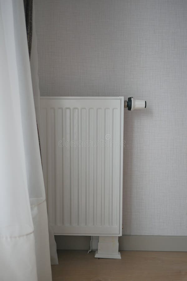 White Radiator on Grey White Wall. Apartment Heating Installation ...