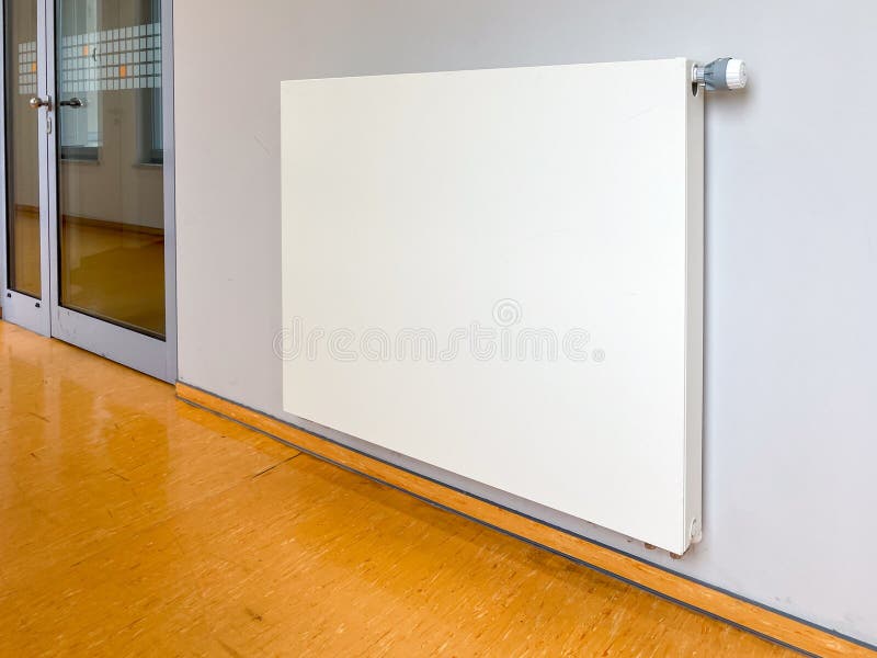 A White Radiator is Mounted on a Wall in a Room Stock Photo - Image of ...