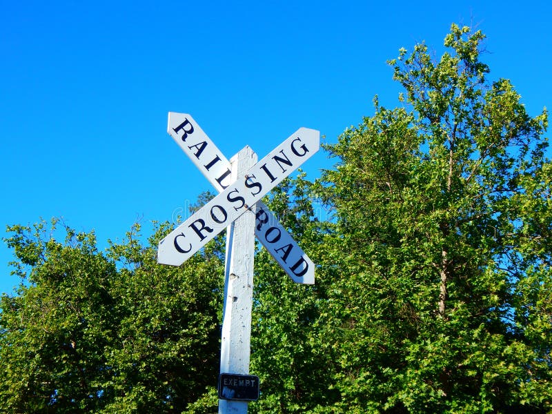 White Rail Road Crossing Sign with Sky and Tree Background Stock Image ...