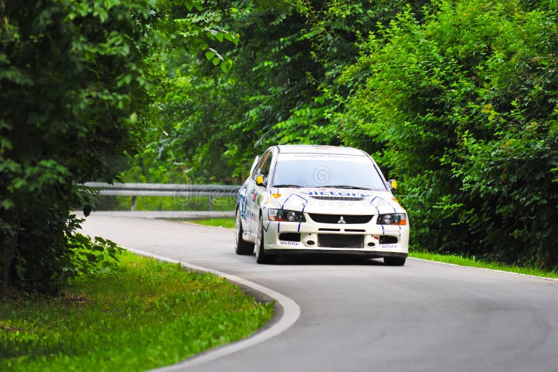 White Rally Car Exiting a Curve during a Race Editorial Image - Image ...
