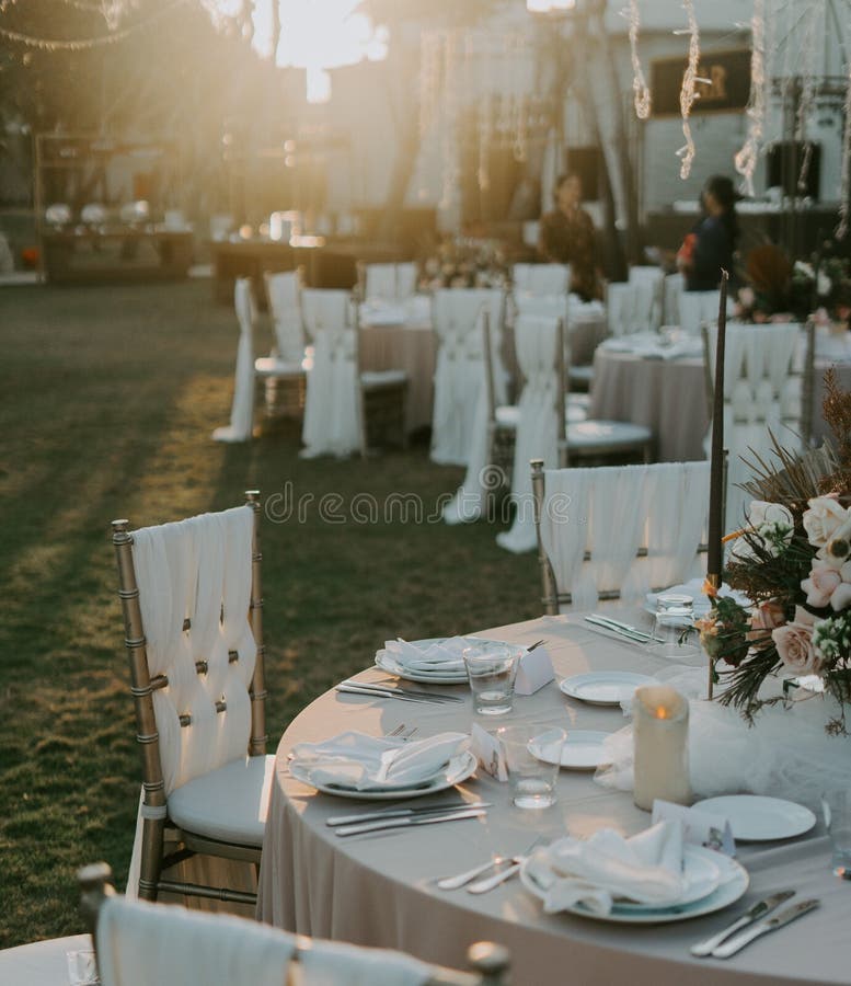 White Reception Table Setting Outdoors Decorated with Flowers and ...