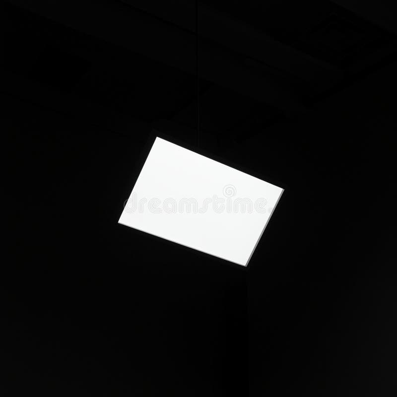A White, Rectangular Ceiling Light Fixture Emits a Soft Glow in a Dark ...
