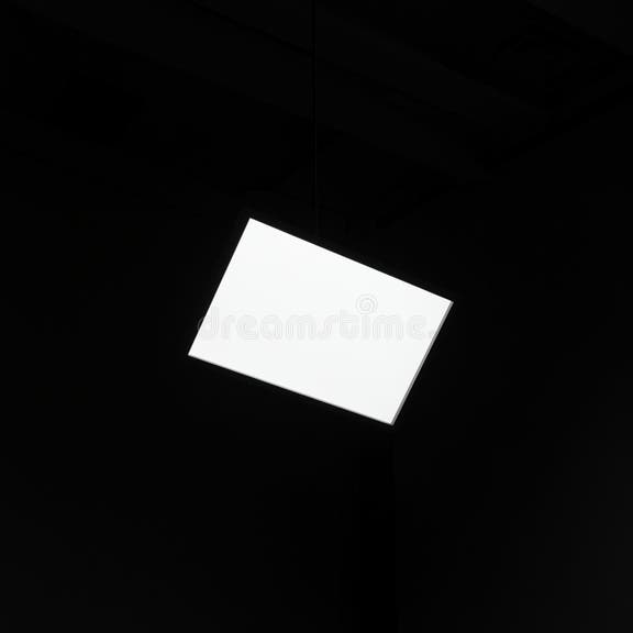 A White, Rectangular Ceiling Light Fixture Emits a Soft Glow in a Dark ...