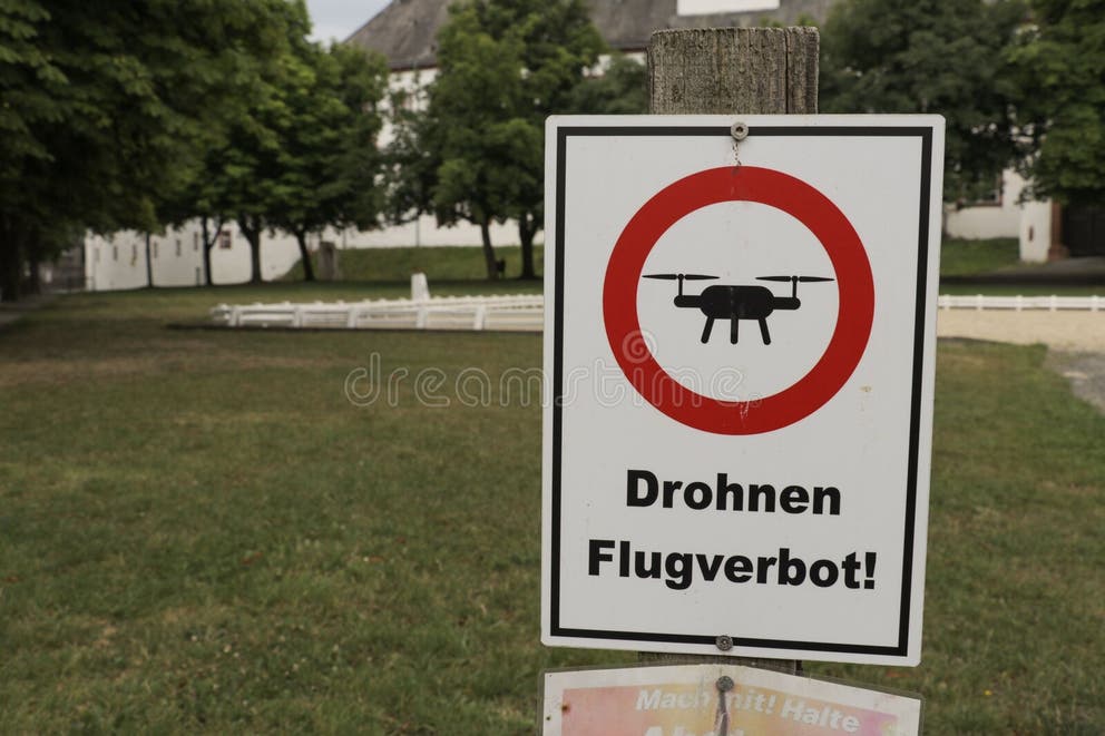White Rectangular Sign with Red and Black Text Reading Drones Flight ...