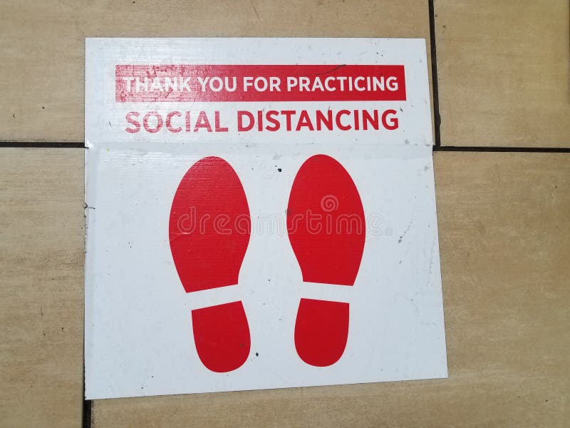 White and Red Social Distancing Sign with Shoes on Ground Stock Photo ...