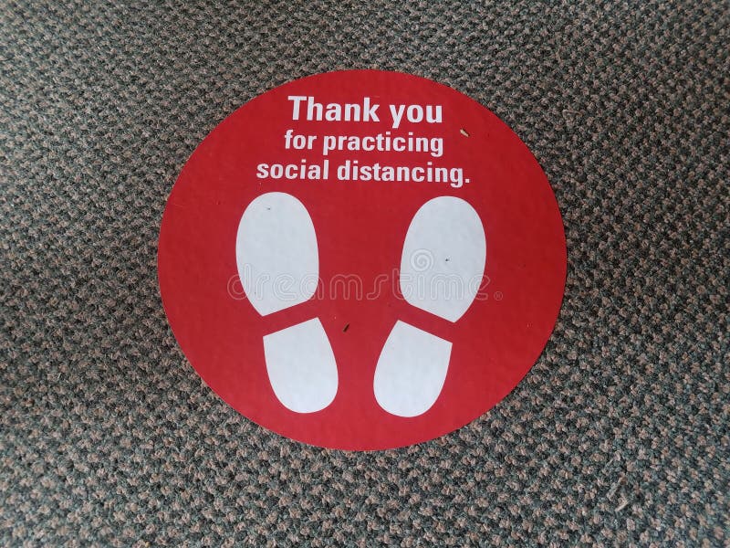 White and Red Social Distancing Sign with Shoes on Ground Stock Image ...