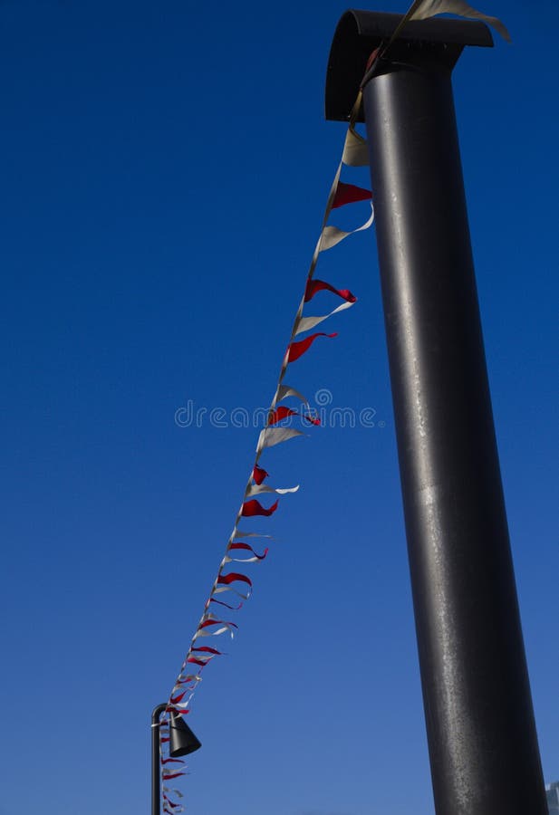 White and Red Triangular Signal Flags on a Blue Sky Background. Stock ...