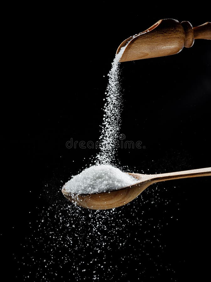 White Refined Sugar Crystals Falling Down into the Wooden Spoon at ...