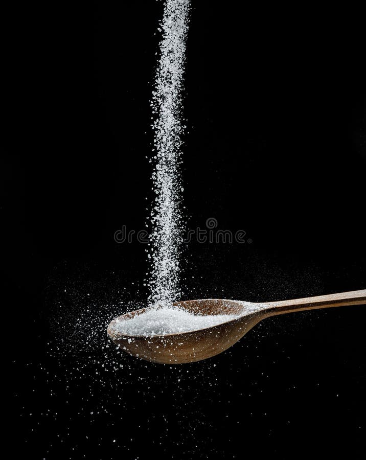 White Refined Sugar Crystals Falling Down into the Wooden Spoon at ...