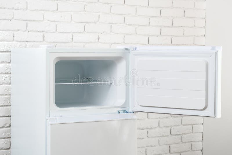 White Refrigerator Open Against Brick Wall Stock Photo - Image of ...
