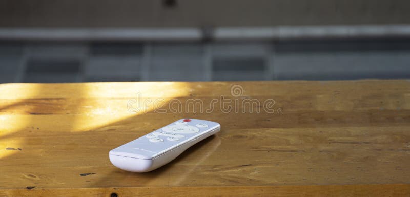 White Remote Control Placed on Wooden Floor Stock Photo - Image of ...