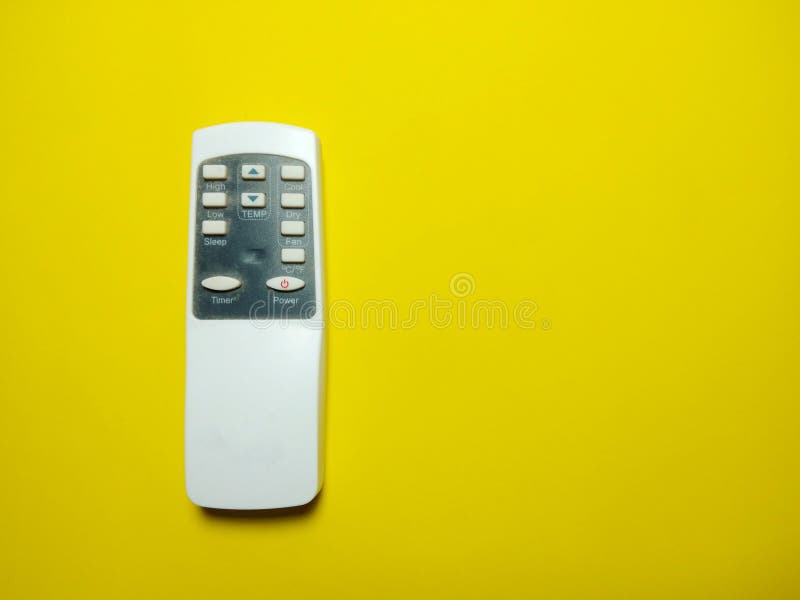 A White Remote Control is Placed on a Yellow Background. Stock Photo ...