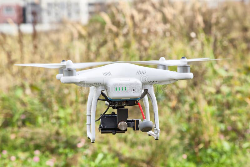 White Remote Controlled Drone in Flight Stock Photo - Image of antenna ...