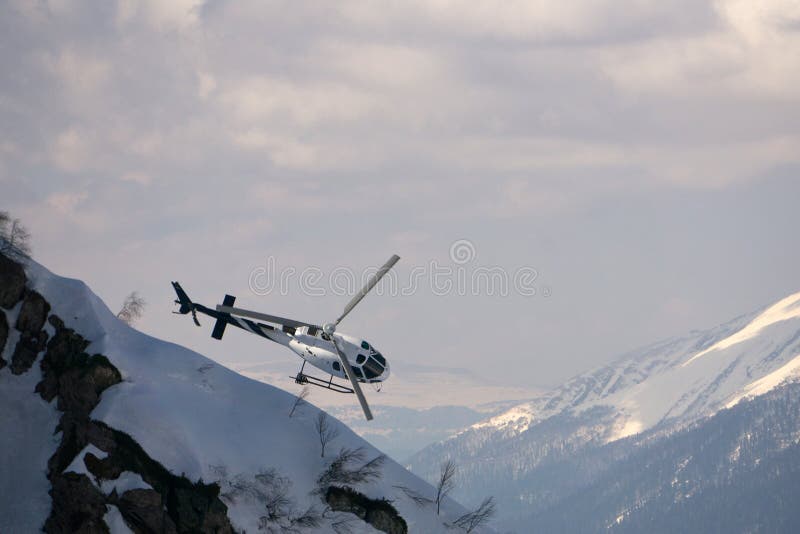 White Rescue Helicopter in the Mountains Stock Photo - Image of ...
