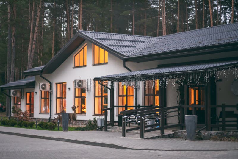 White Restaurant Building with Gable Roof in Pine Forest, with Burning ...