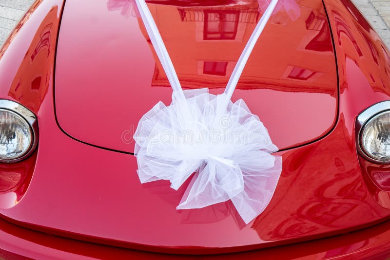 White ribbon on a red car stock photo. Image of wedding - 42232558
