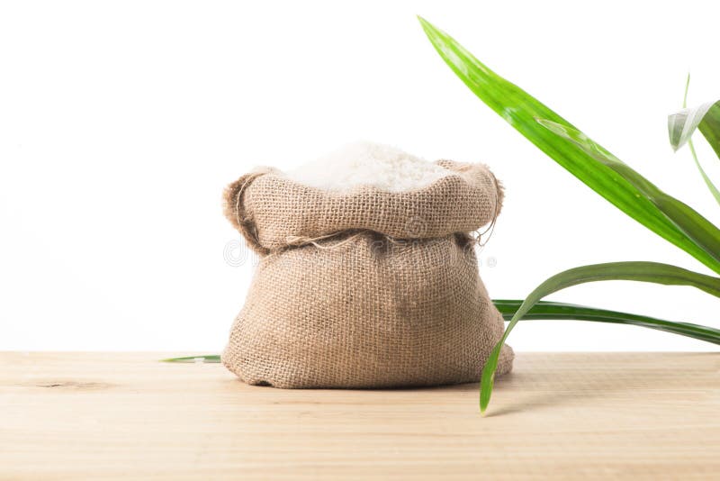 White Rice in Burlap Sack with Green Leaves Stock Photo - Image of ...