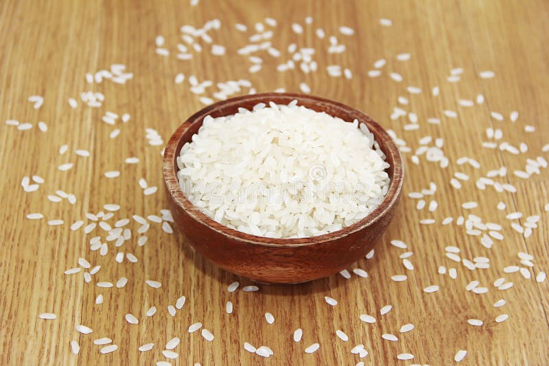 White Rice for Cooking in Brown Wooden Plate Stock Image - Image of ...