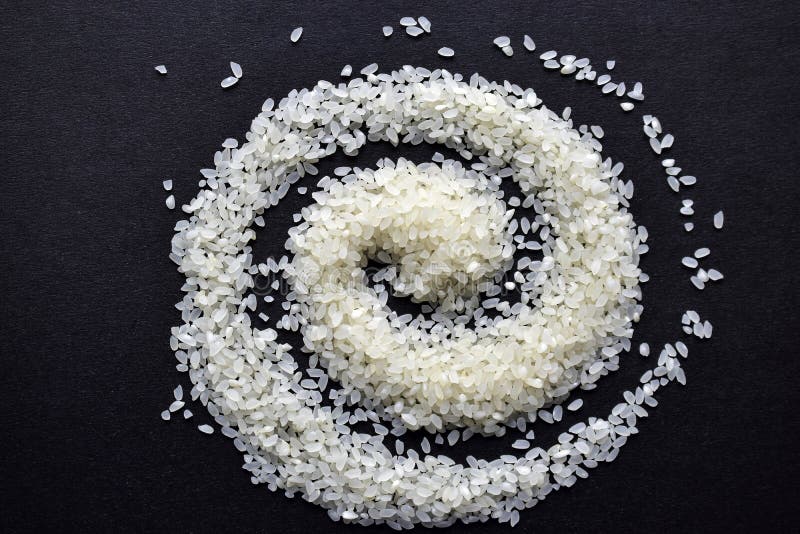 White Rice Curled into a Curl on a Black Background Stock Image - Image ...