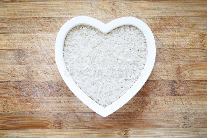 Rice on heart shaped board stock photo. Image of food - 22123036