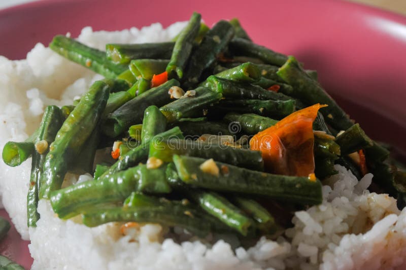 White Rice with Long Bean Stir-fried Vegetables on a Red Plastic Plate ...