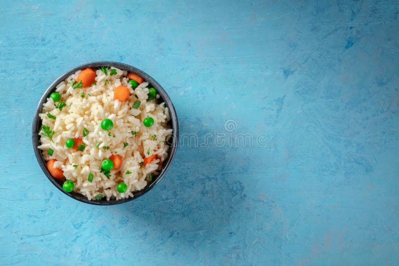White Rice with Vegetables, Top Shot on a Blue Background Stock Photo ...