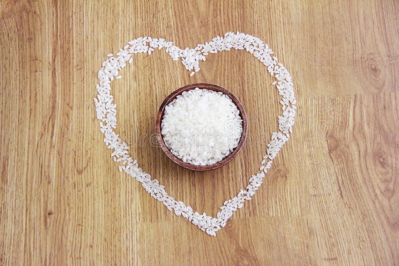 White Rice in a Wooden Plate and Rice Pattern in the Shape of a Heart ...