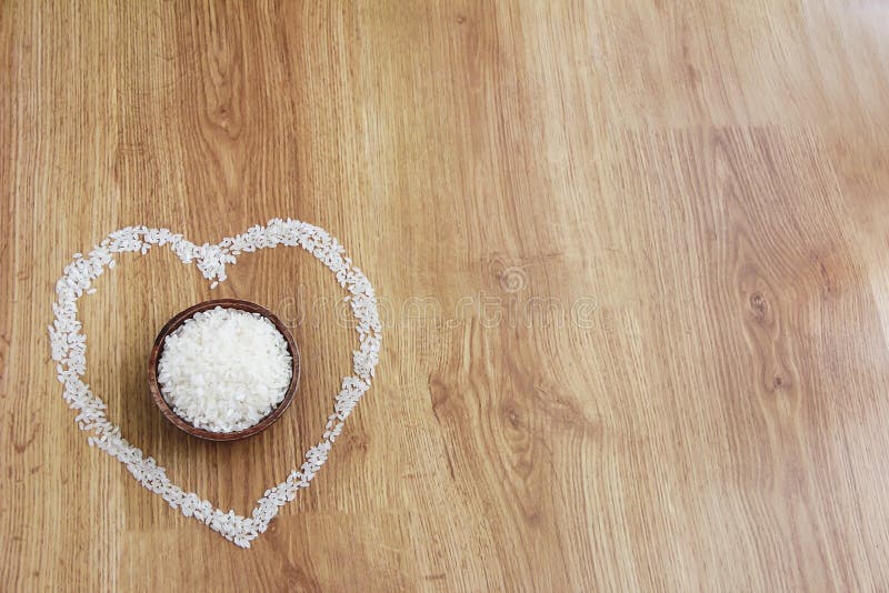 White Rice in a Wooden Plate and Rice Pattern in the Shape of a Heart ...