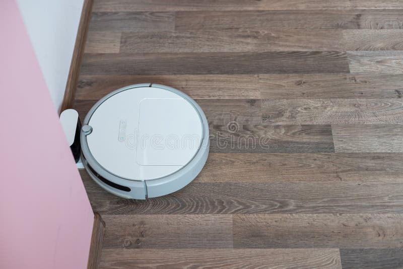 The White Robot (robotic) Vacuum Cleaner is Charging on Its Base. Top ...