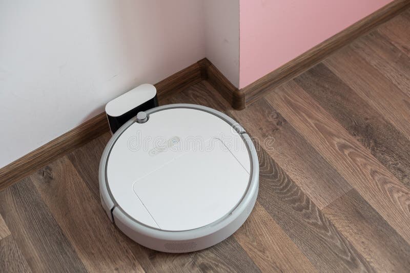 The White Robot (robotic) Vacuum Cleaner is Charging on Its Base. Top ...
