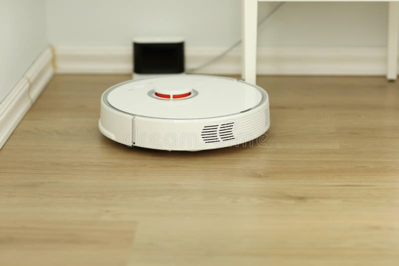 White Robotic Vacuum Cleaner The Robot Is Controlled By Voice Commands For Direct Cleaning