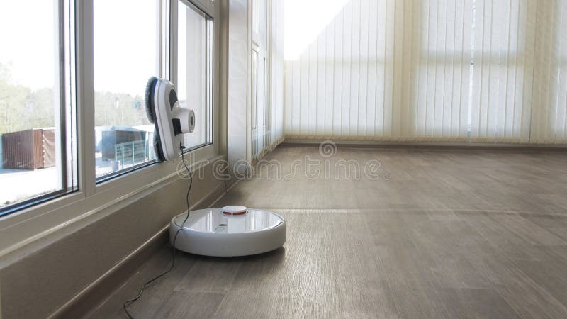 White Robotic Vacuum Cleaner and Robot Window Cleaner Work Together ...