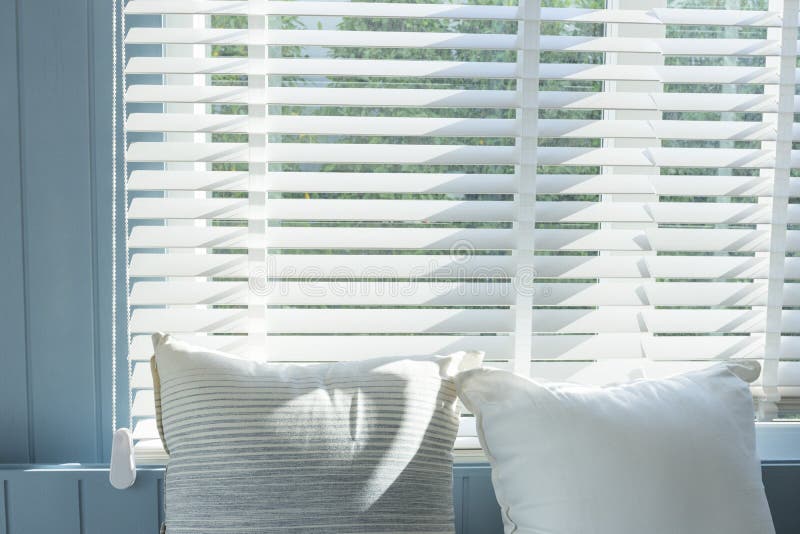 White Roller Blinds or Louver Curtains at the Glass Window Stock Photo ...