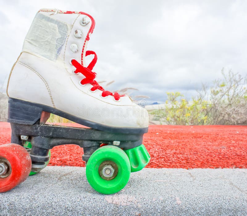 A White Roller Skate with Red Laces is on a Red Surface Stock Image ...