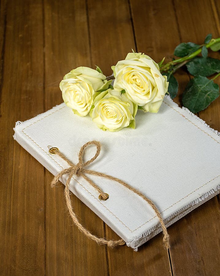 White roses on journal stock photo. Image of string - 111494474