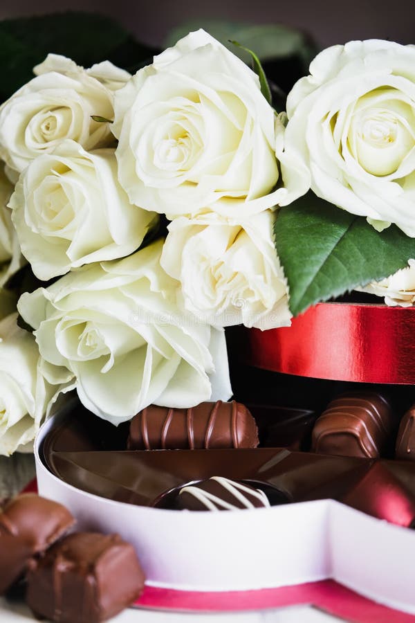 Chocolate Candies and Bouquet of Roses Stock Photo - Image of flowers ...