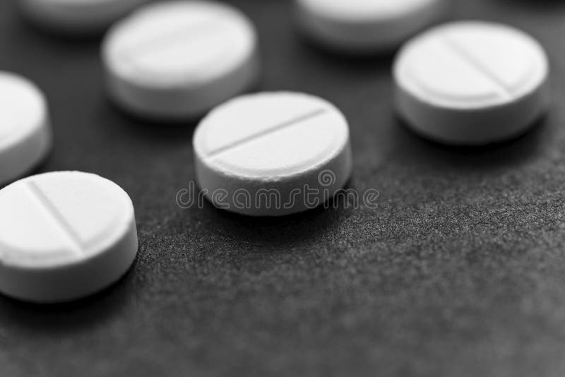White round pills in row stock photo. Image of health - 95450418