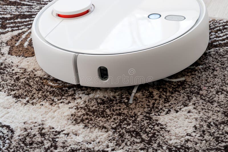 White Round Robotic Vacuum Cleaner on Fitted Carpet Floor Stock Image ...
