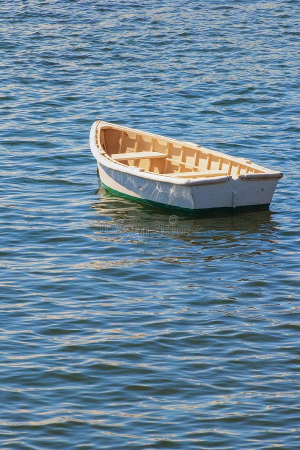 White Row Boat Resting on the Ripples of Waves. Stock Image - Image of ...