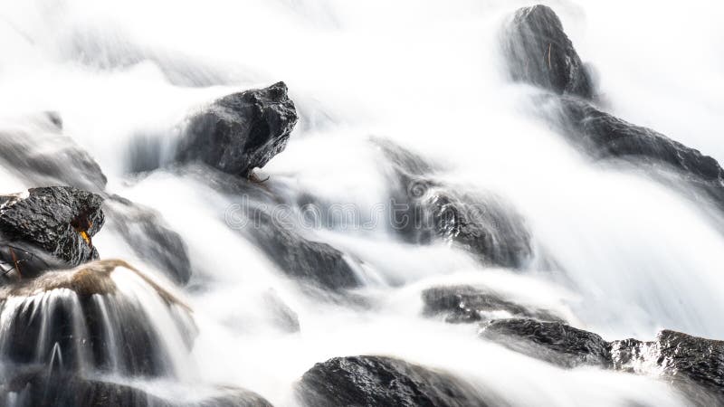 White Rushing Water Flowing Over Exposed Jagged Rocks Stock Image ...