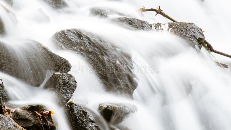 White Rushing Water Flowing Over Exposed Jagged Rocks Stock Photo ...