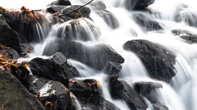 White Rushing Water Flowing Over Exposed Jagged Rocks Stock Photo ...