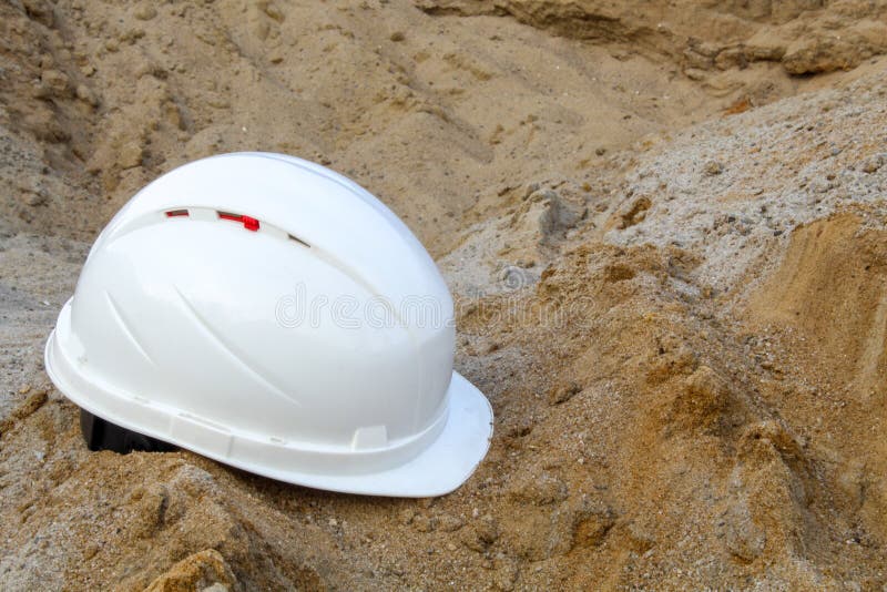 White Safety Helmet Lying on the Sand. Construction Tool Stock Image ...