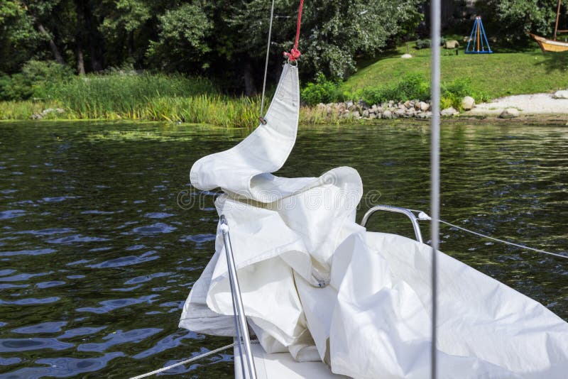 White Sail on the Bow of the Yacht. Blue Water Stock Photo - Image of ...
