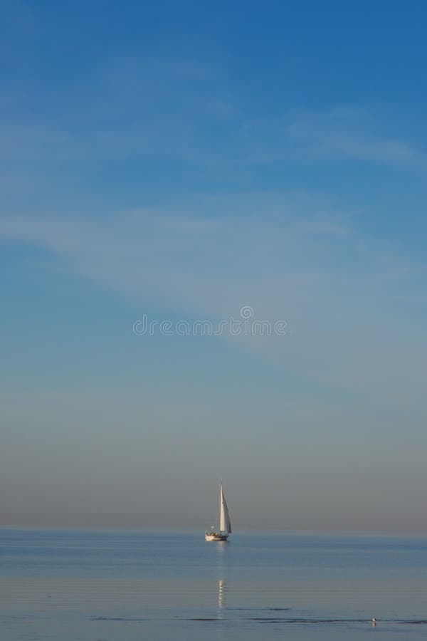 White Sailing Ship Floats on the Sea and the Water is Very Still Stock ...