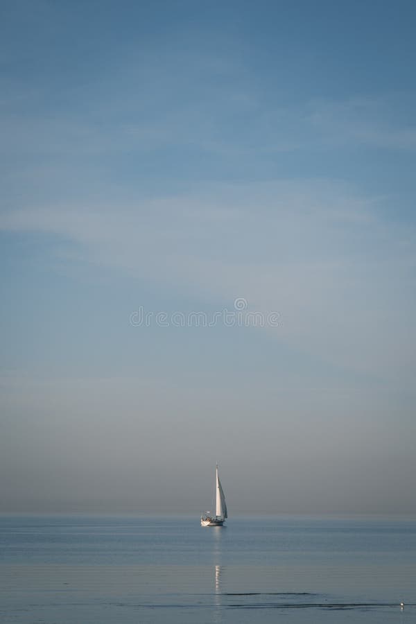 White Sailing Ship Floats on the Sea and the Water is Very Still Stock ...